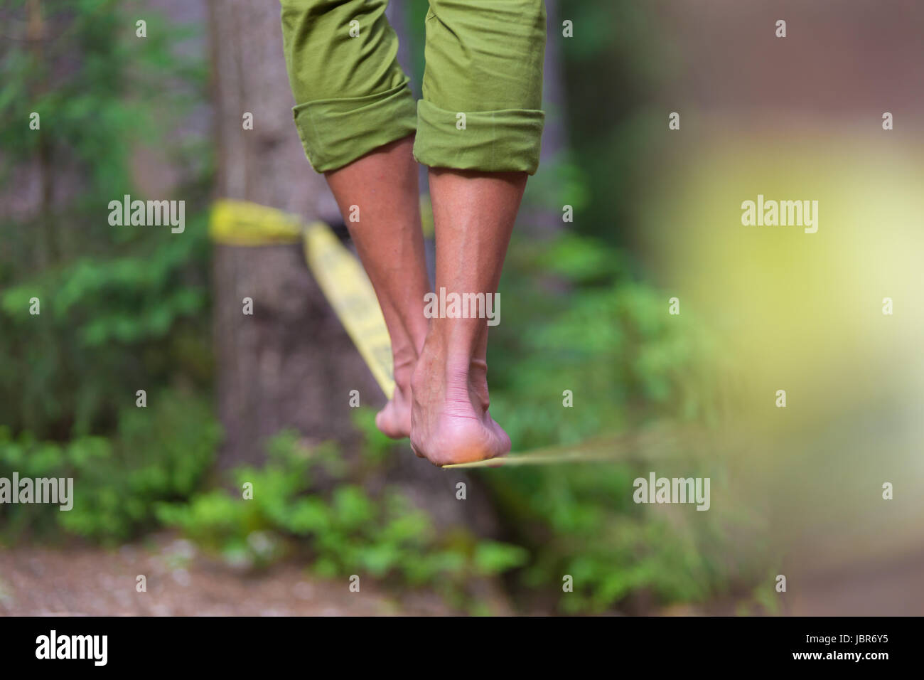 Slacklining is a practice in balance that typically uses nylon or ...