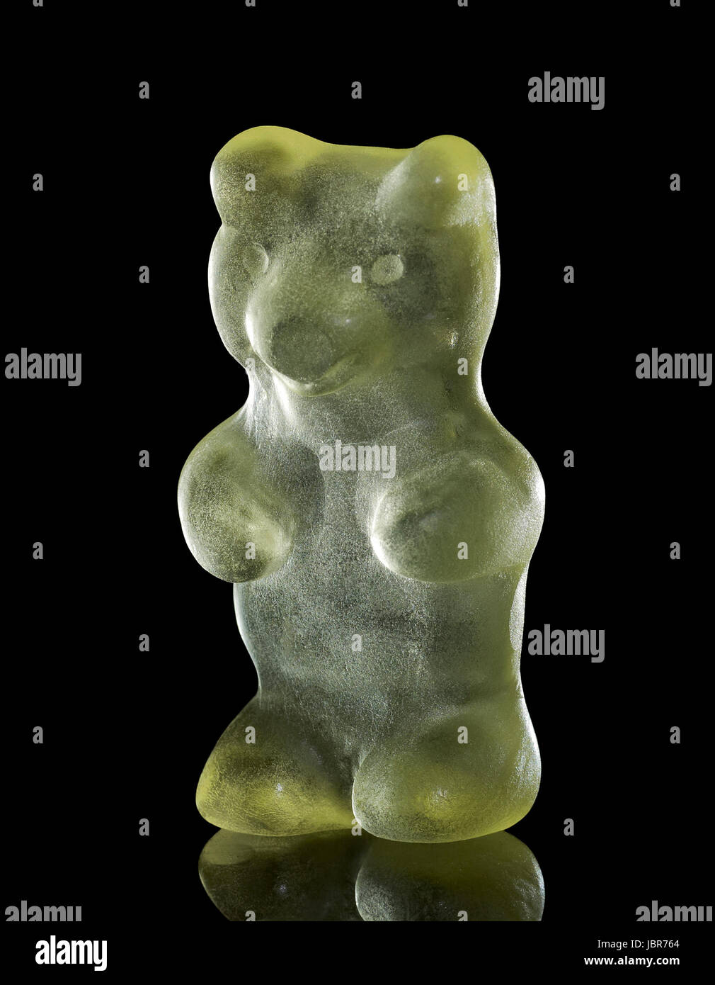 green translucent gummy bear in black reflective back Stock Photo - Alamy