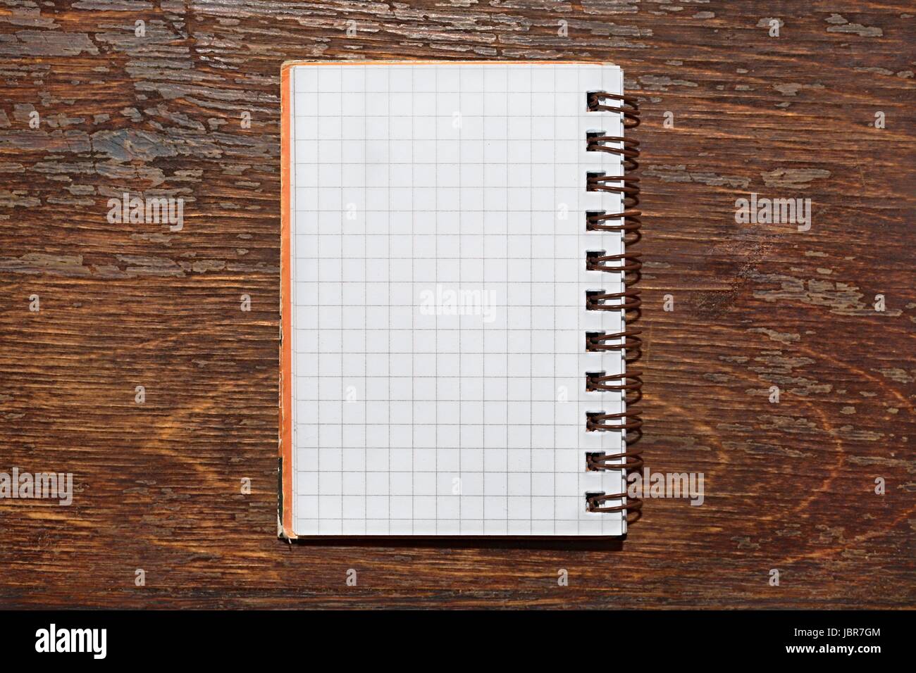 Notebook with square grid on a table Stock Photo - Alamy