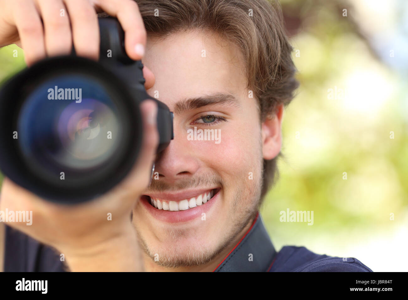 Front view of a photographer photographing with a dslr camera showing ...
