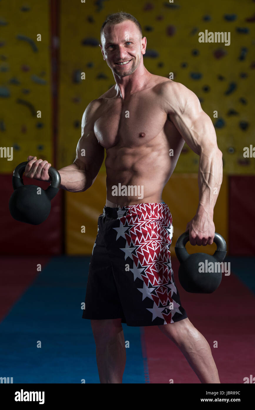 Man Working Out With Kettle Bell In A Gym - Bodybuilder Doing Heavy ...
