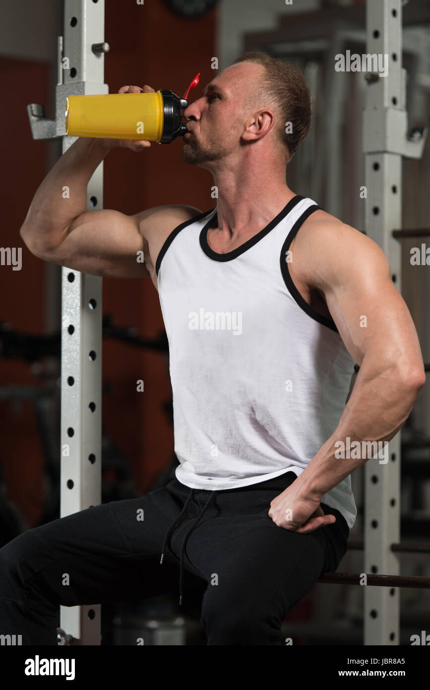 Muscular Man Resting After Exercise And Drinking From Shaker Stock ...
