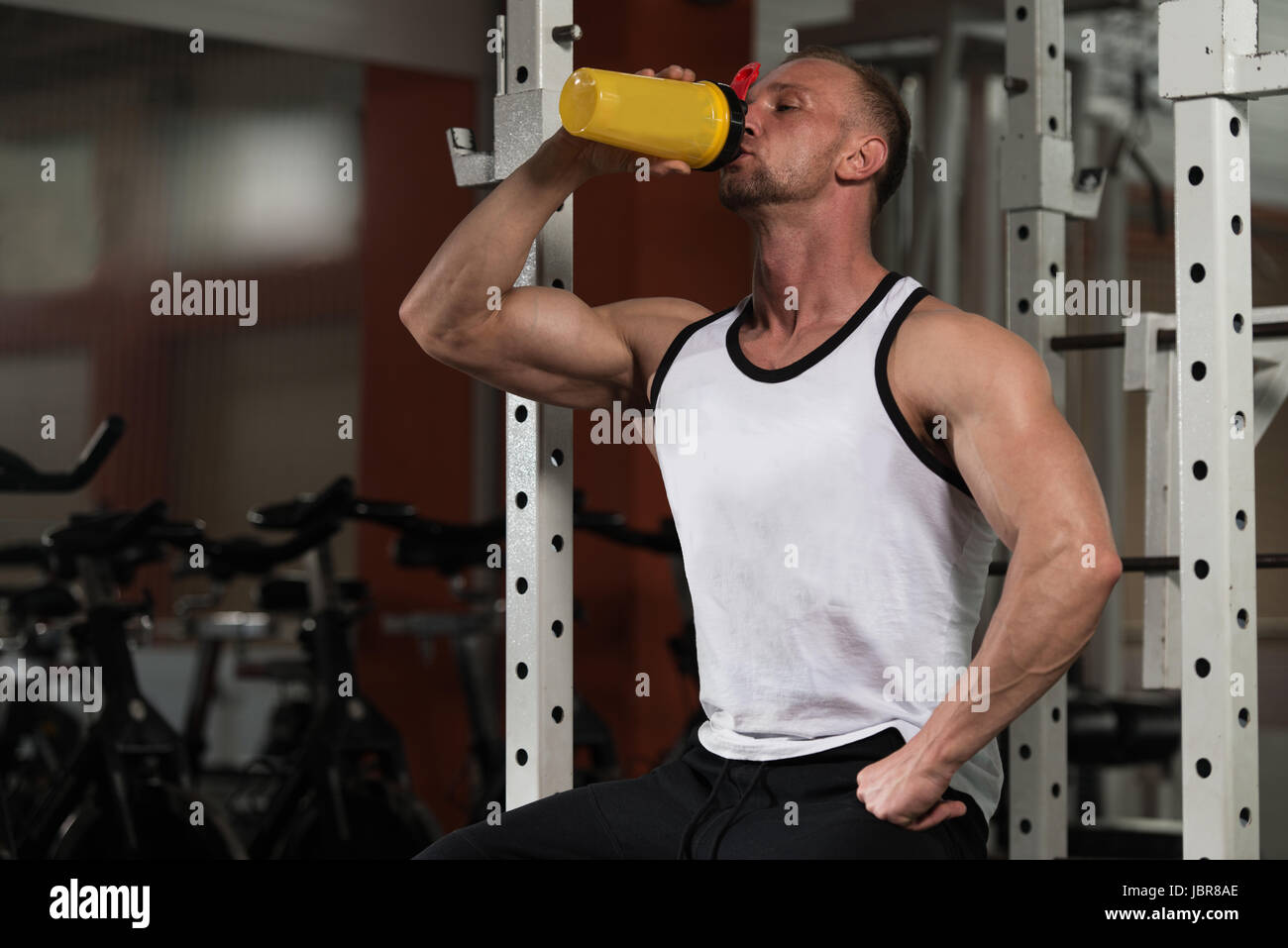 Muscular Man Resting After Exercise And Drinking From Shaker Stock ...