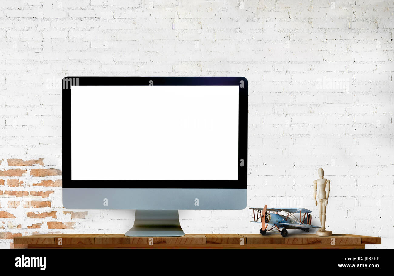 Mock up Desktop computer on wooden table with white brick wall. Blank ...