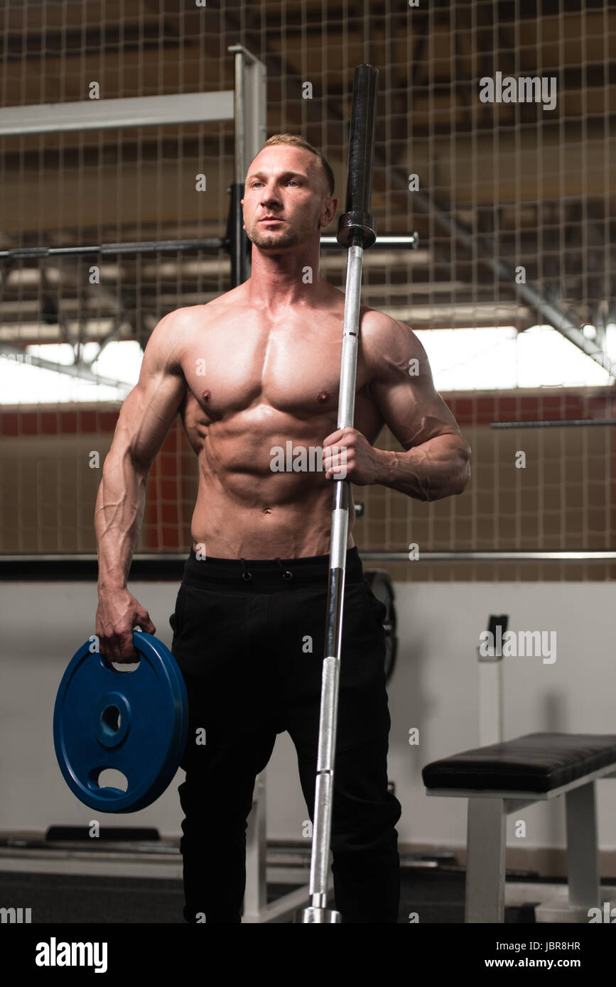 Portrait Of A Physically Fit Man Showing His Well Trained Body In Gym ...