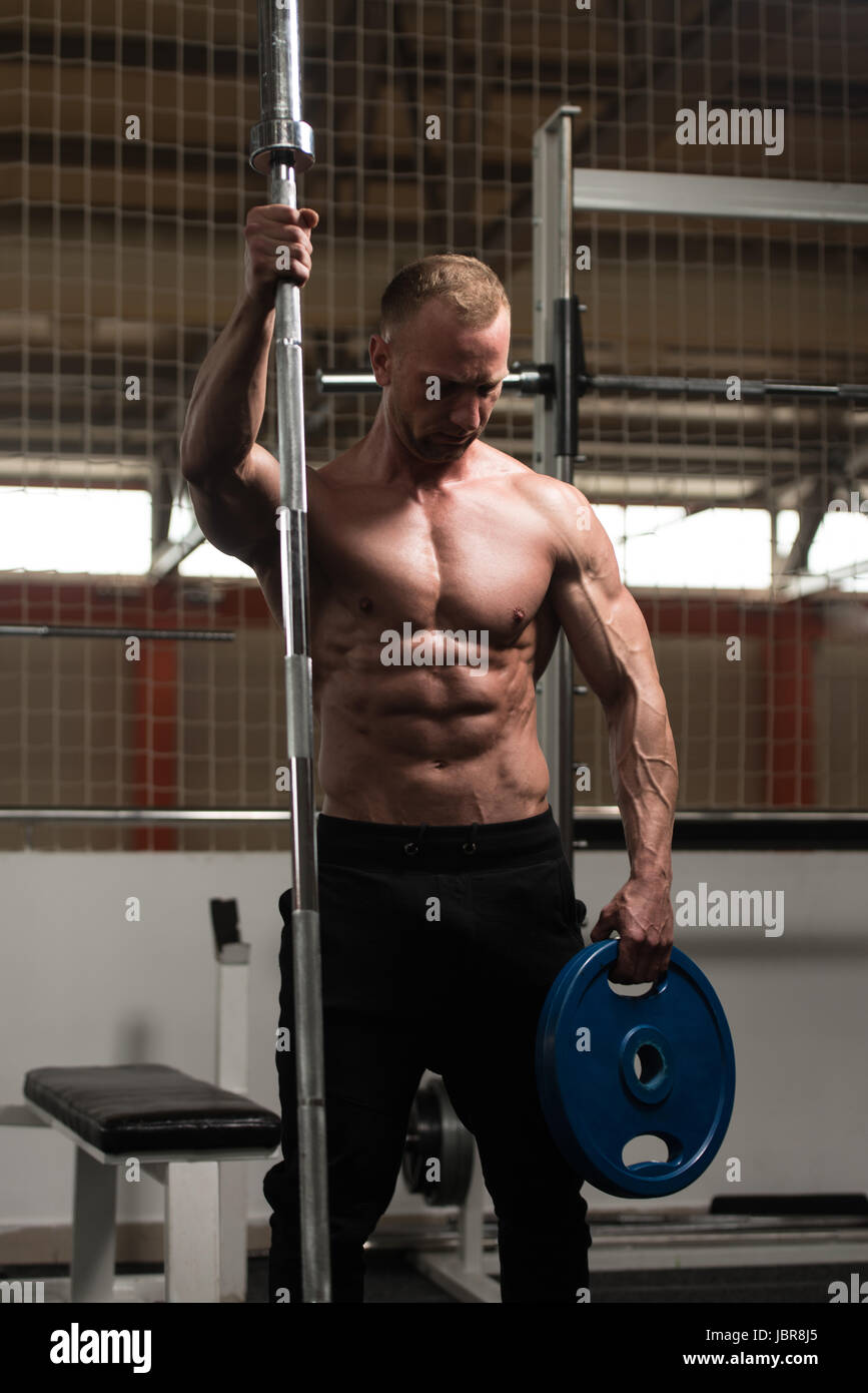Portrait Of A Physically Fit Man Posing In Modern Fitness Center Gym ...