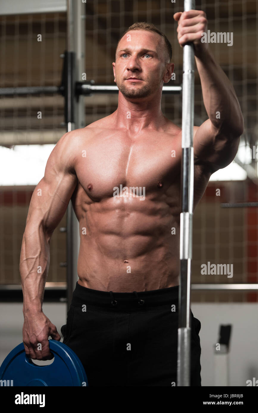 Portrait Of A Physically Fit Man Showing His Well Trained Body In Gym ...