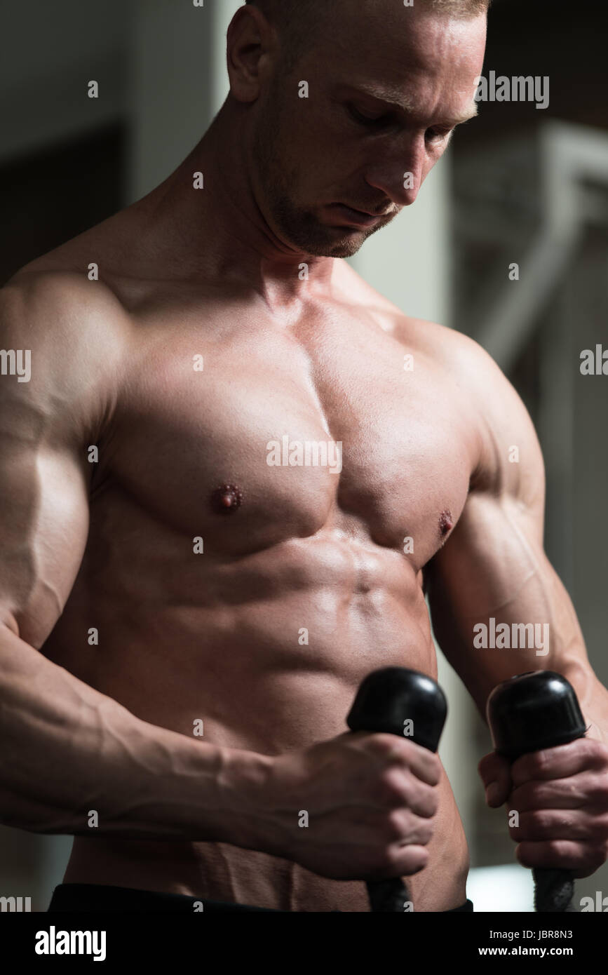 Muscular Fitness Bodybuilder Doing Heavy Weight Exercise For Biceps On ...