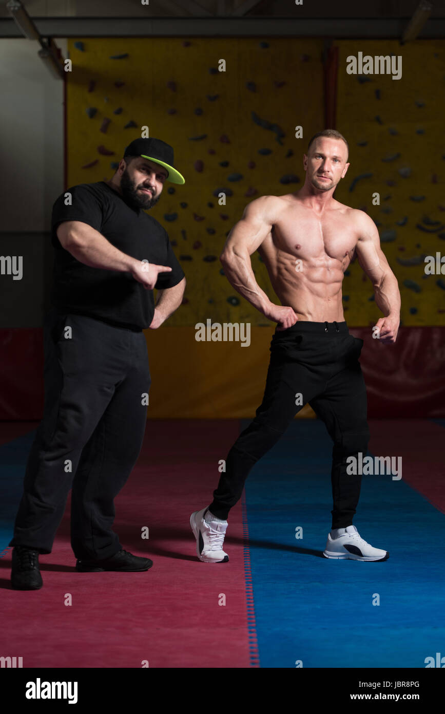 Portrait Of A Man Posing Bodybuilding Poses In Fitness Center and ...