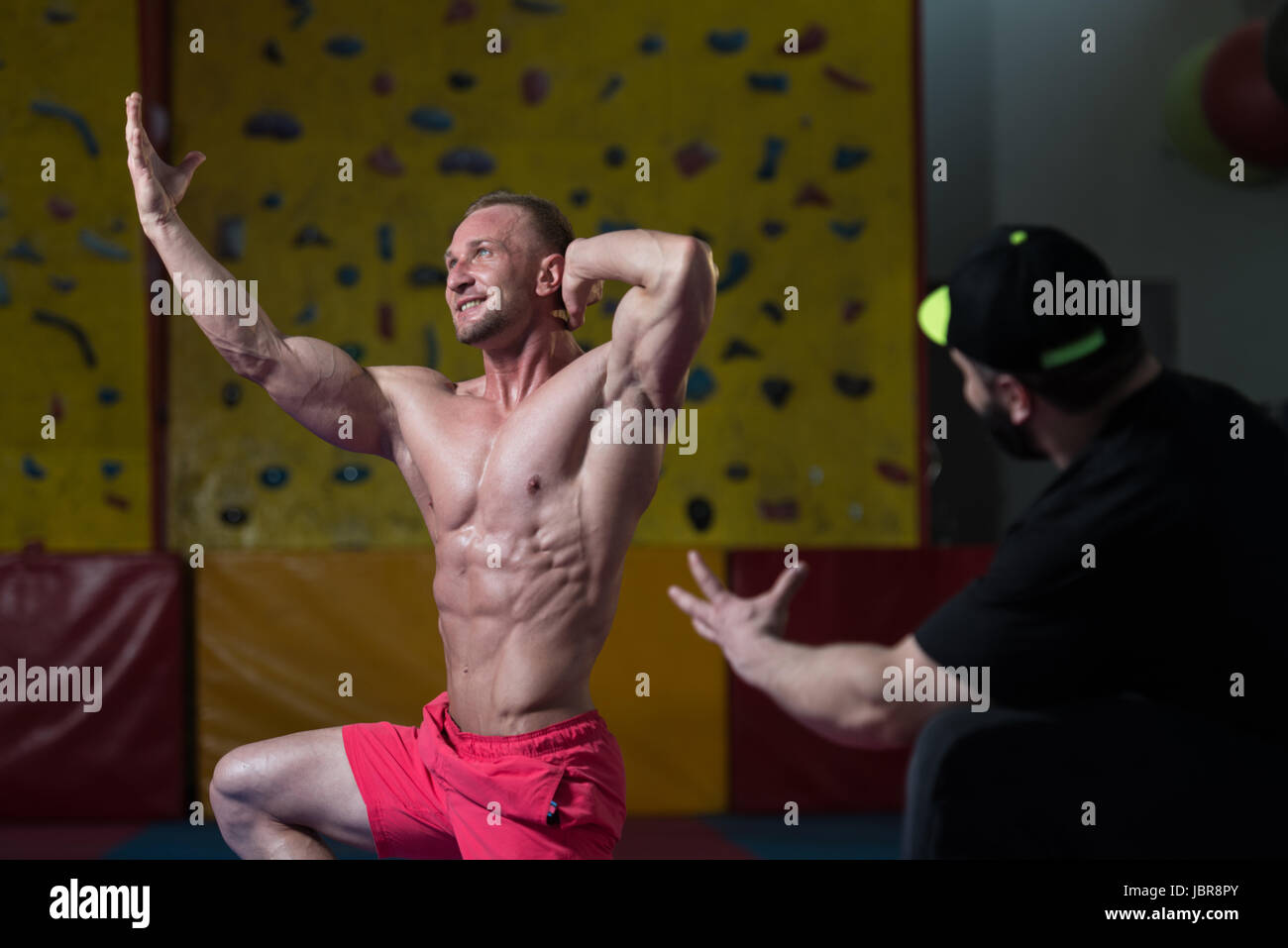 Portrait Of A Man Posing Bodybuilding Poses In Fitness Center and ...