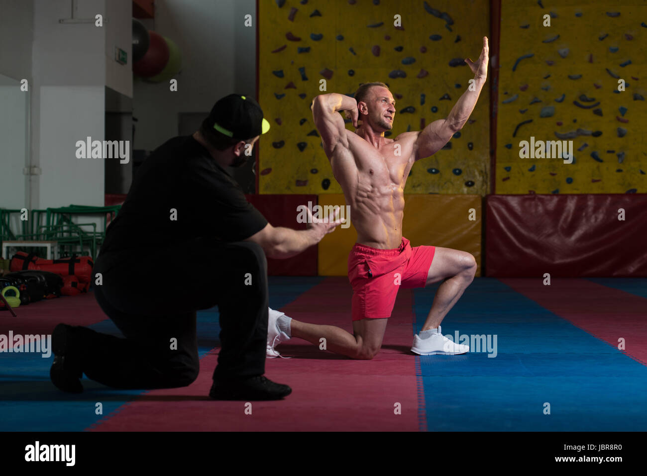Portrait Of A Man Posing Bodybuilding Poses In Fitness Center and ...