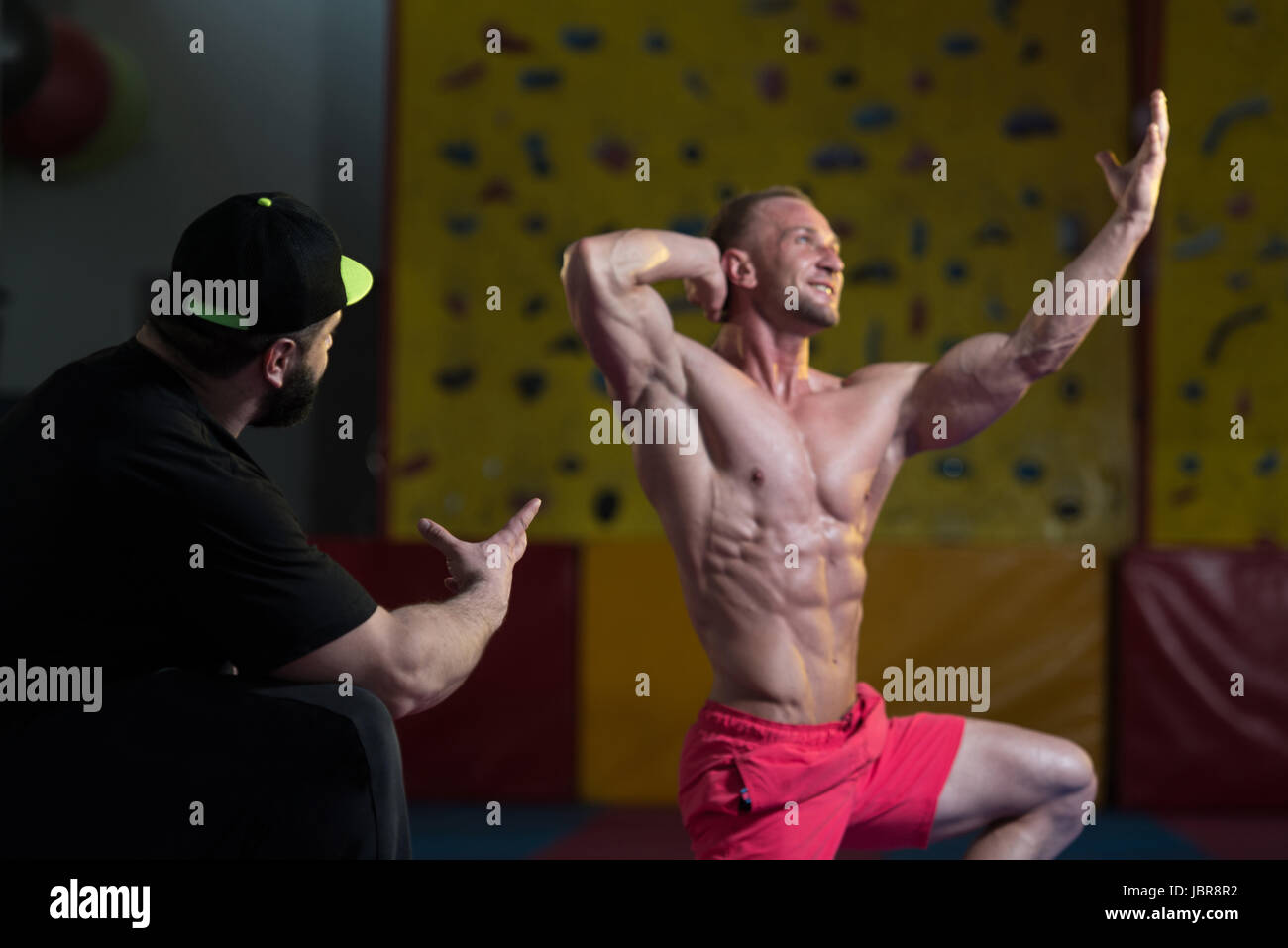 Portrait Of A Man Posing Bodybuilding Poses In Fitness Center and ...
