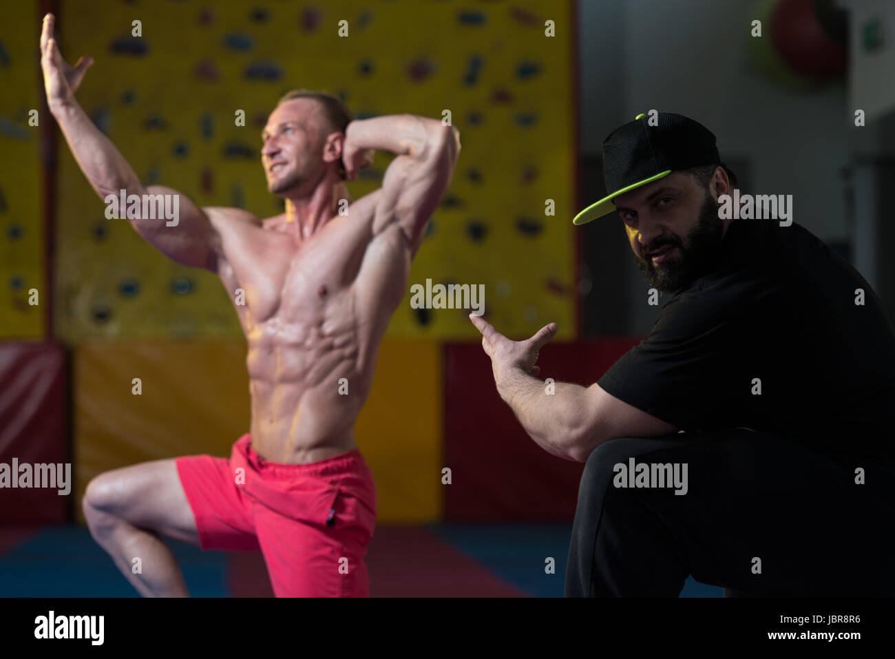 Portrait Of A Man Posing Bodybuilding Poses In Fitness Center and ...