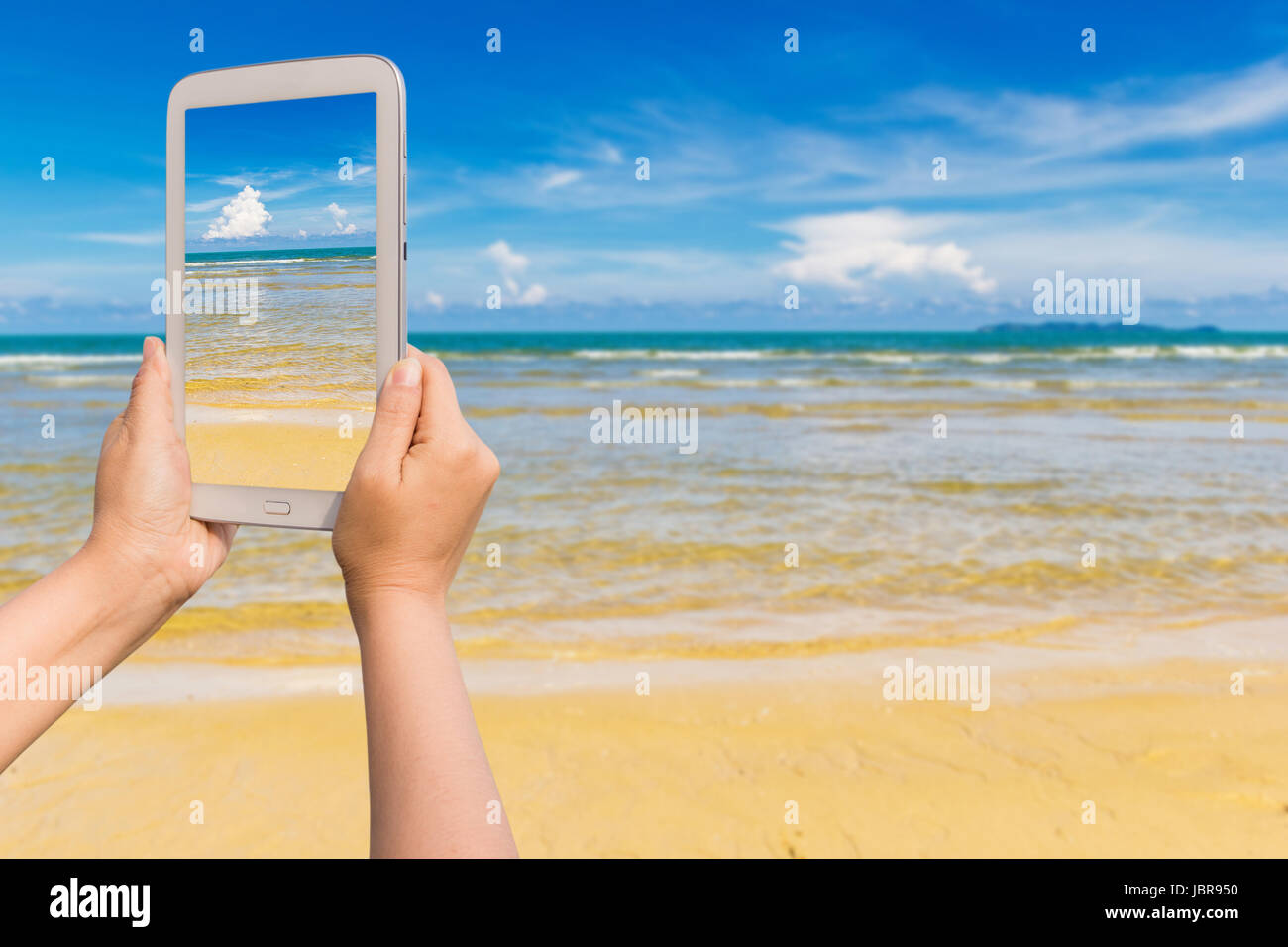 Tablet vacation on the beach Stock Photo - Alamy