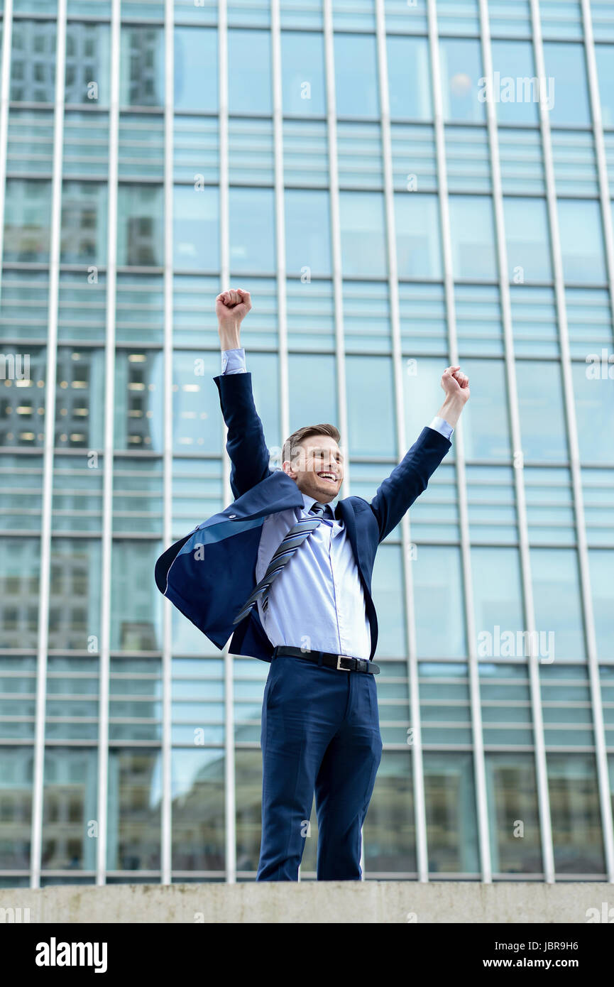 Happy young businessman celebrating his success Stock Photo - Alamy