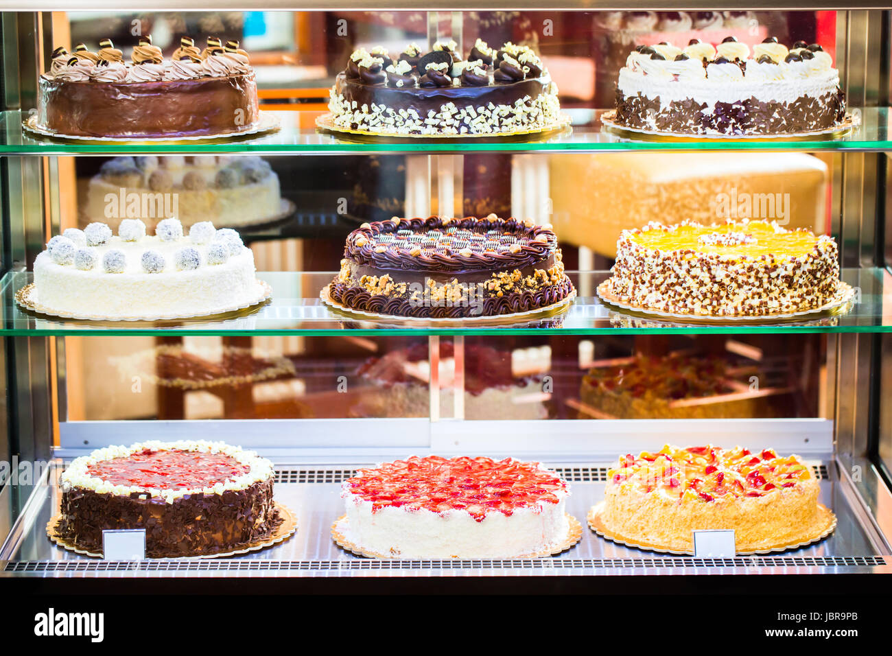 Pastry shop glass display with selection of cream or fruit cake Stock ...