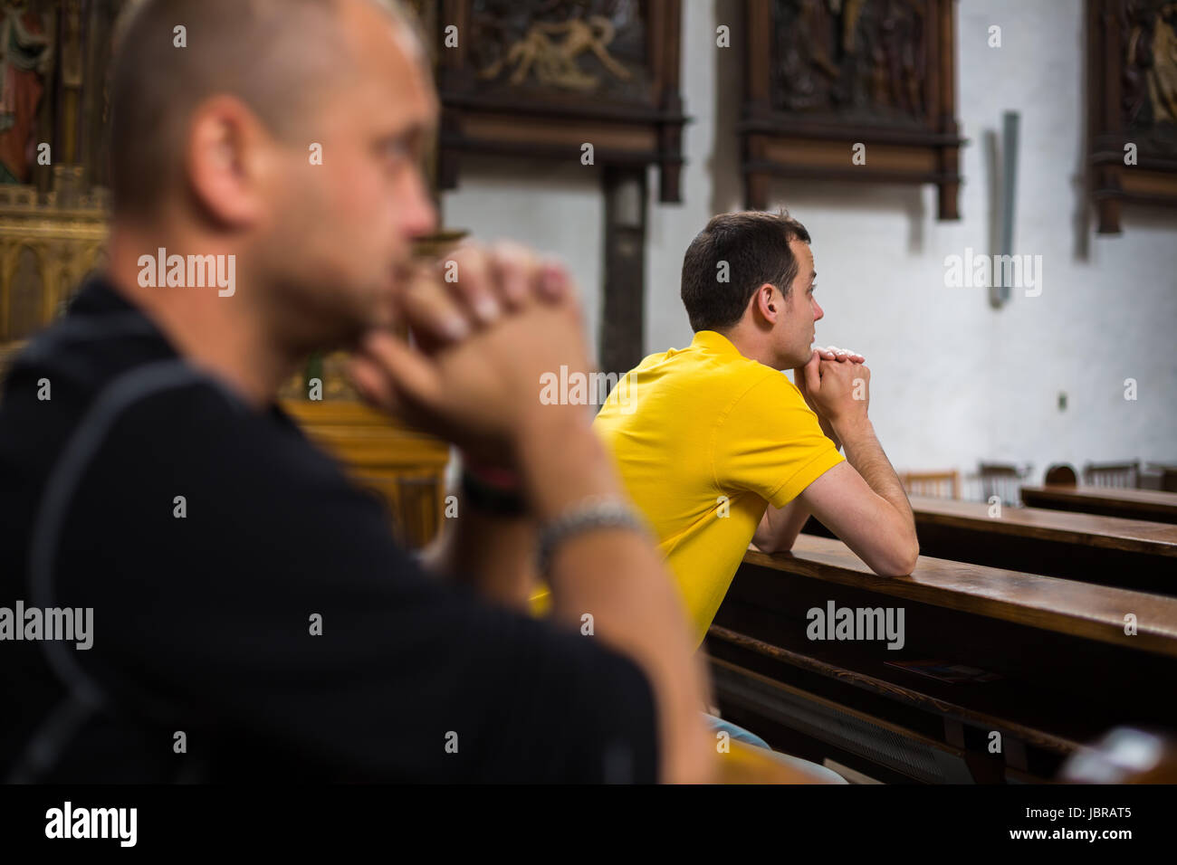 Handsome young man praying in a church Stock Photo - Alamy