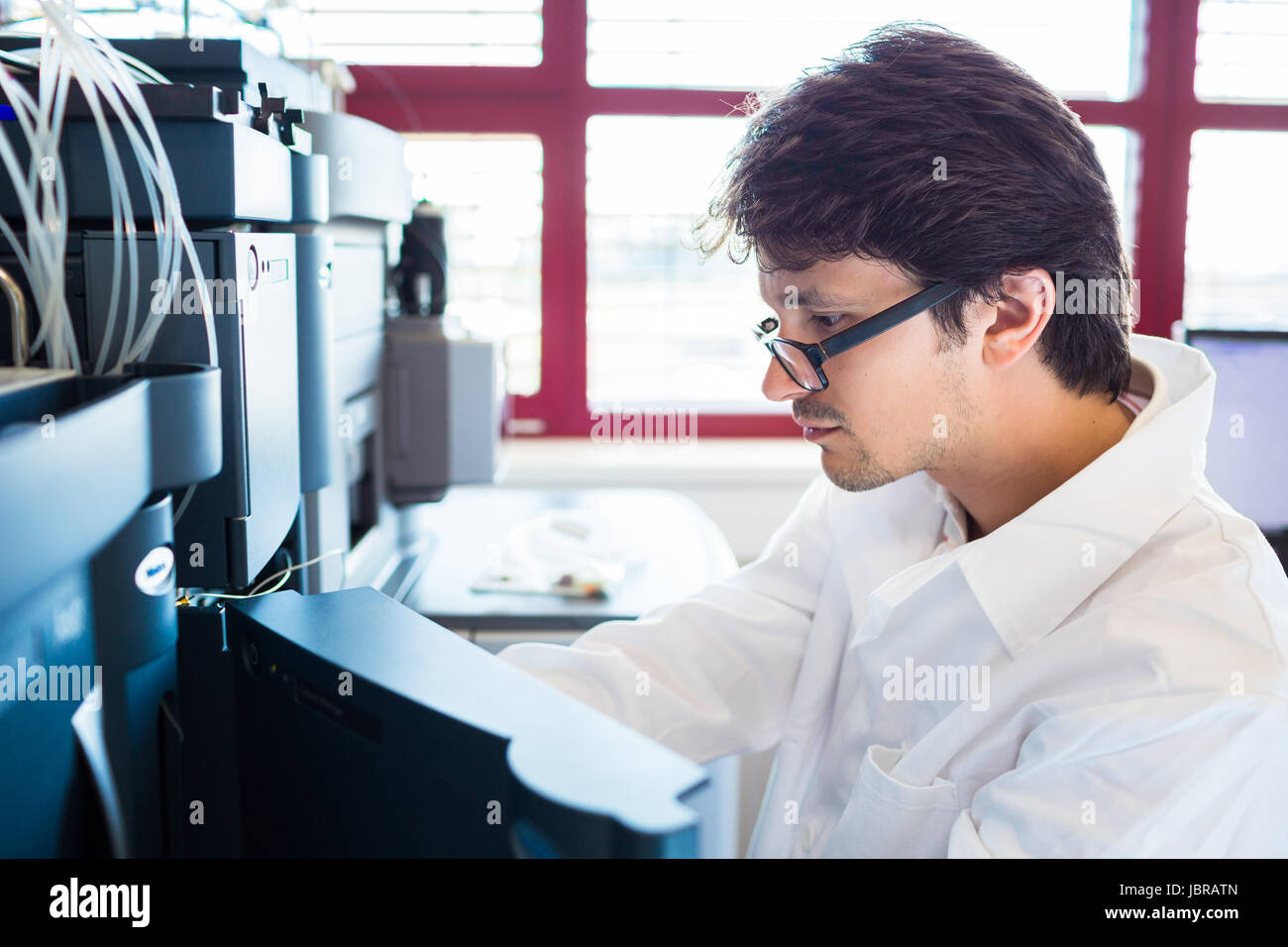 Male researcher carrying out scientific research in a lab (shallow DOF ...