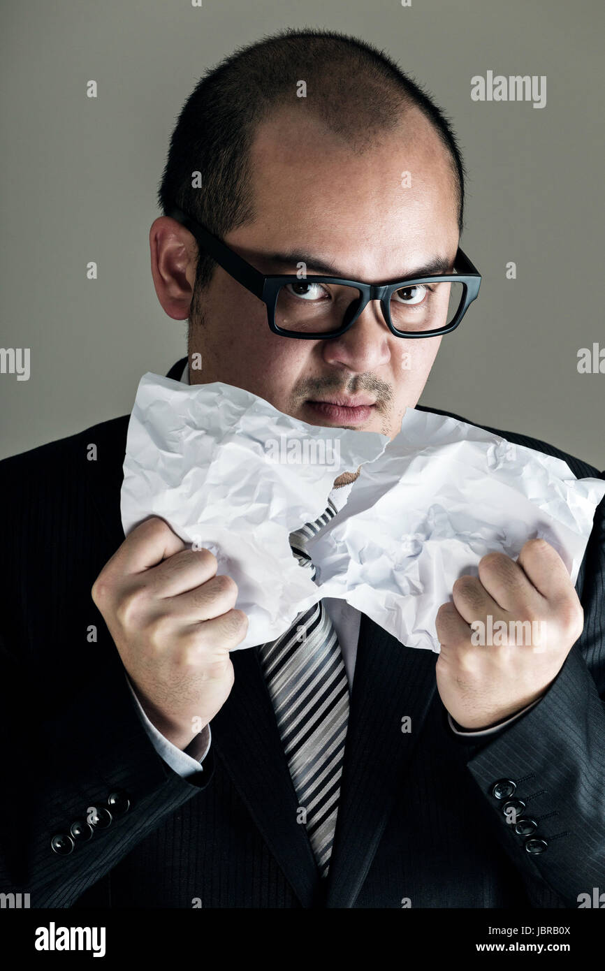 Boss getting angry and tear off paper Stock Photo - Alamy