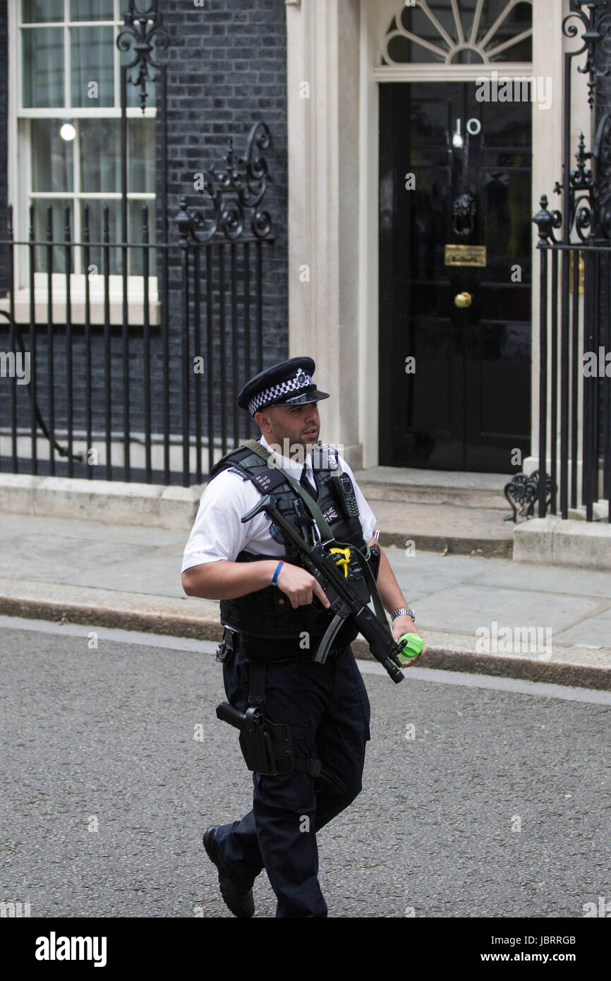 London, UK. 12th June, 2017. An armed police officer passes in front of ...