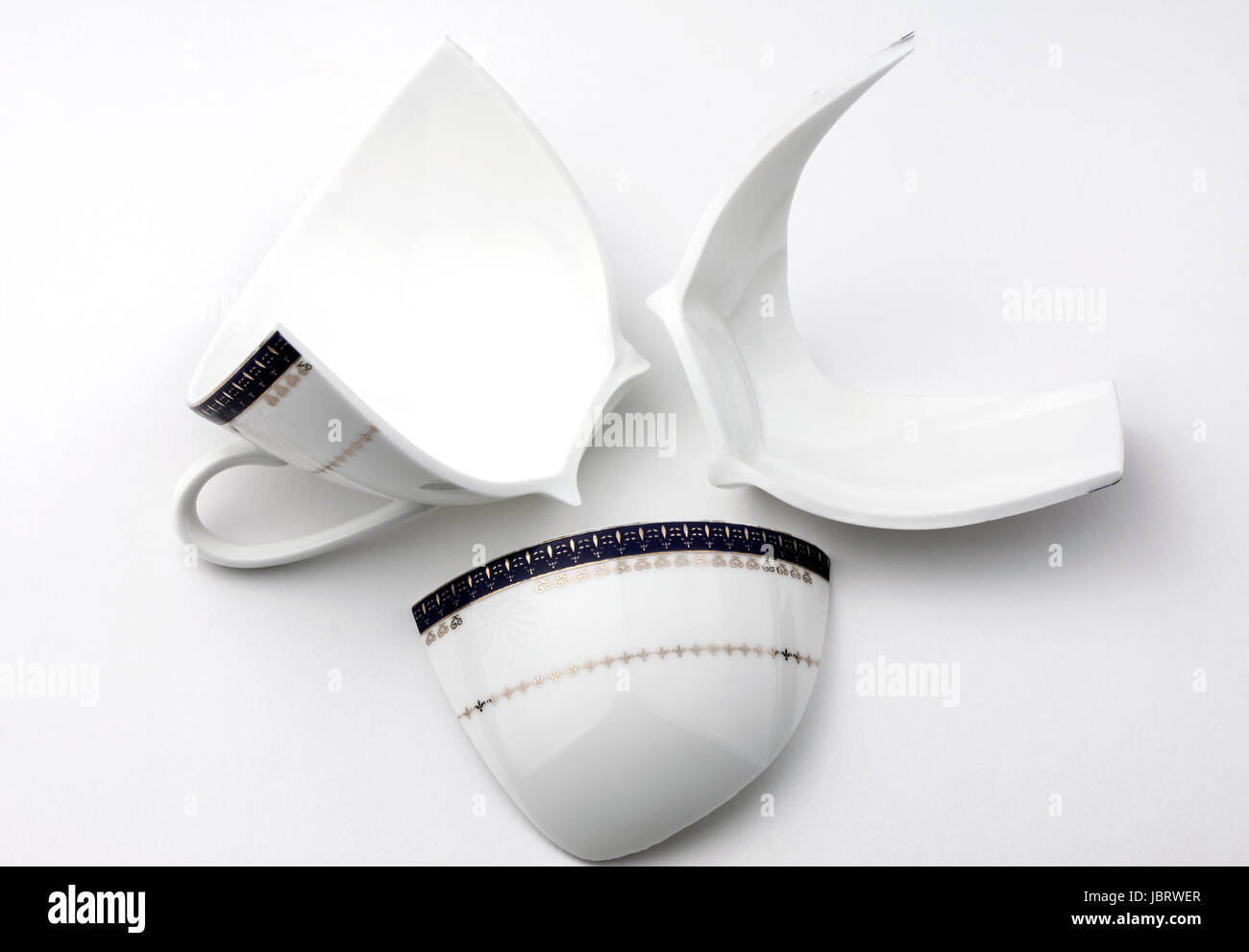 Three pieces of broken cup on white background Stock Photo - Alamy