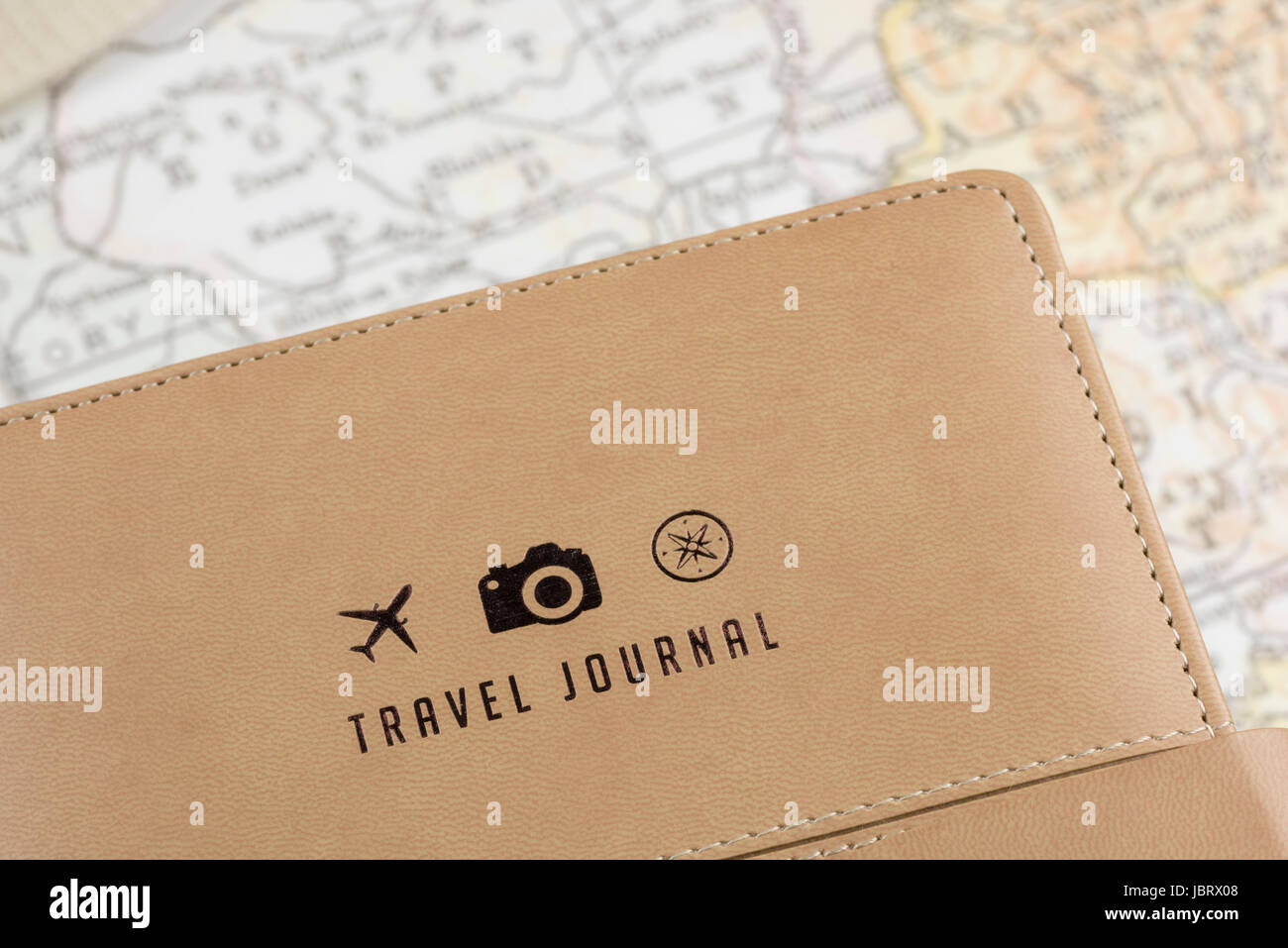 Close-up of a Travel Journal cover with 3 small logos (a plane, a ...