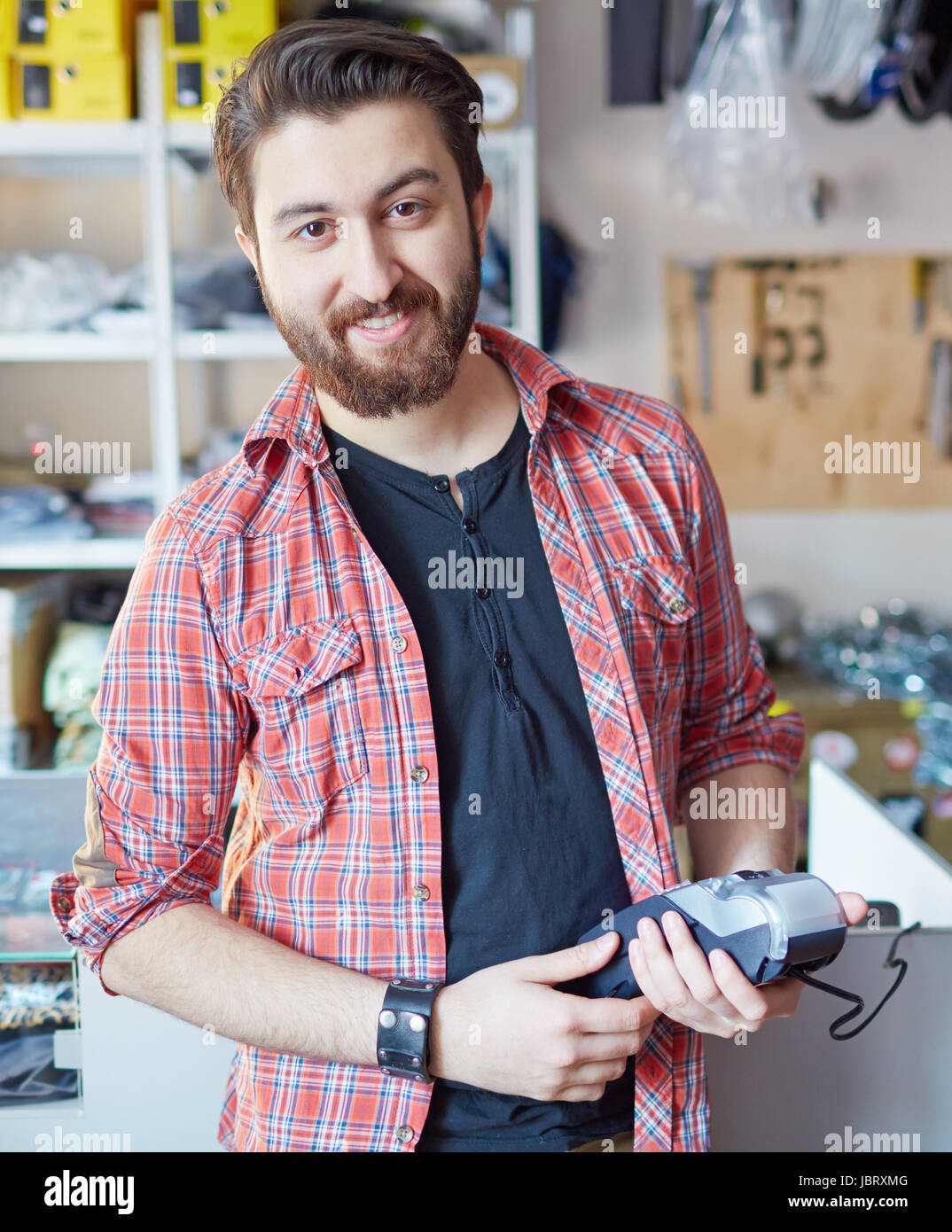 Portrait of a handsome man at the cash register looking at camera Stock ...