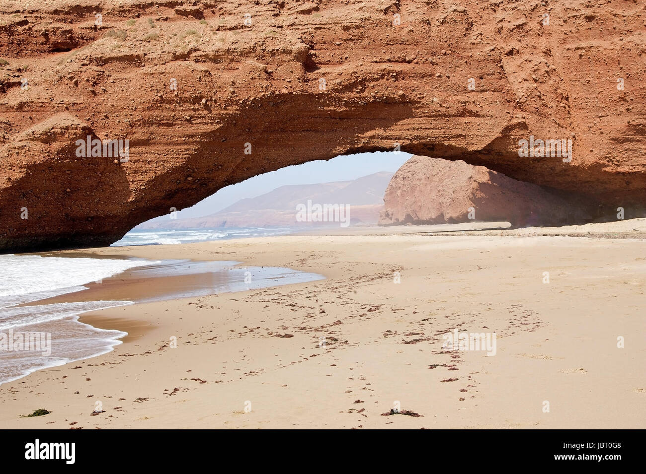 Natural arch on the Atlantic Ocean coast at legzira beach in the South ...