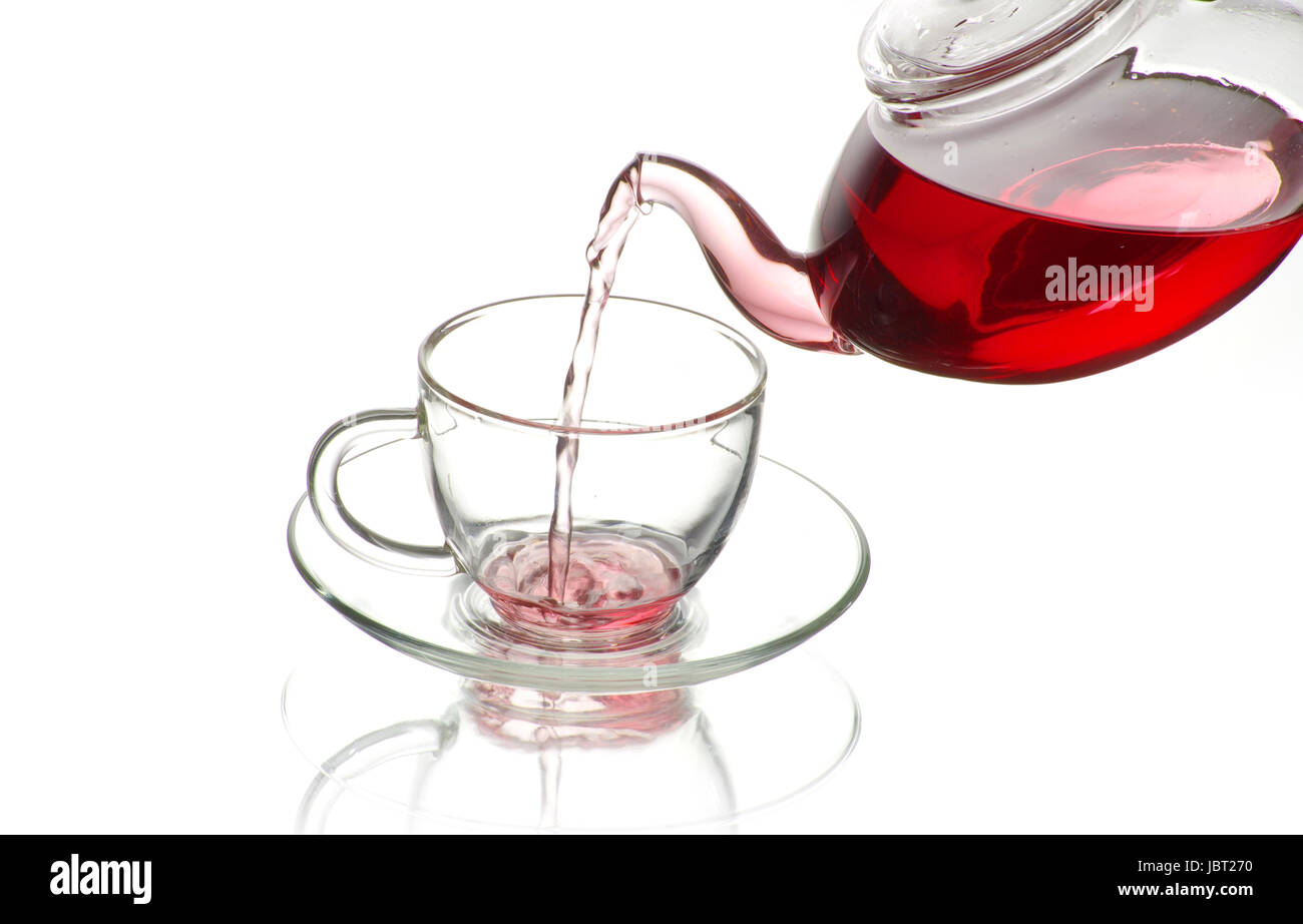 Tea being poured into glass tea cup Stock Photo - Alamy
