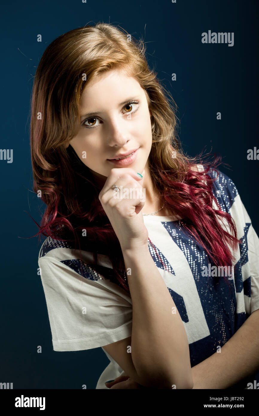 Studio fashion portrait of young beautiful girl with nice eyes on dark ...