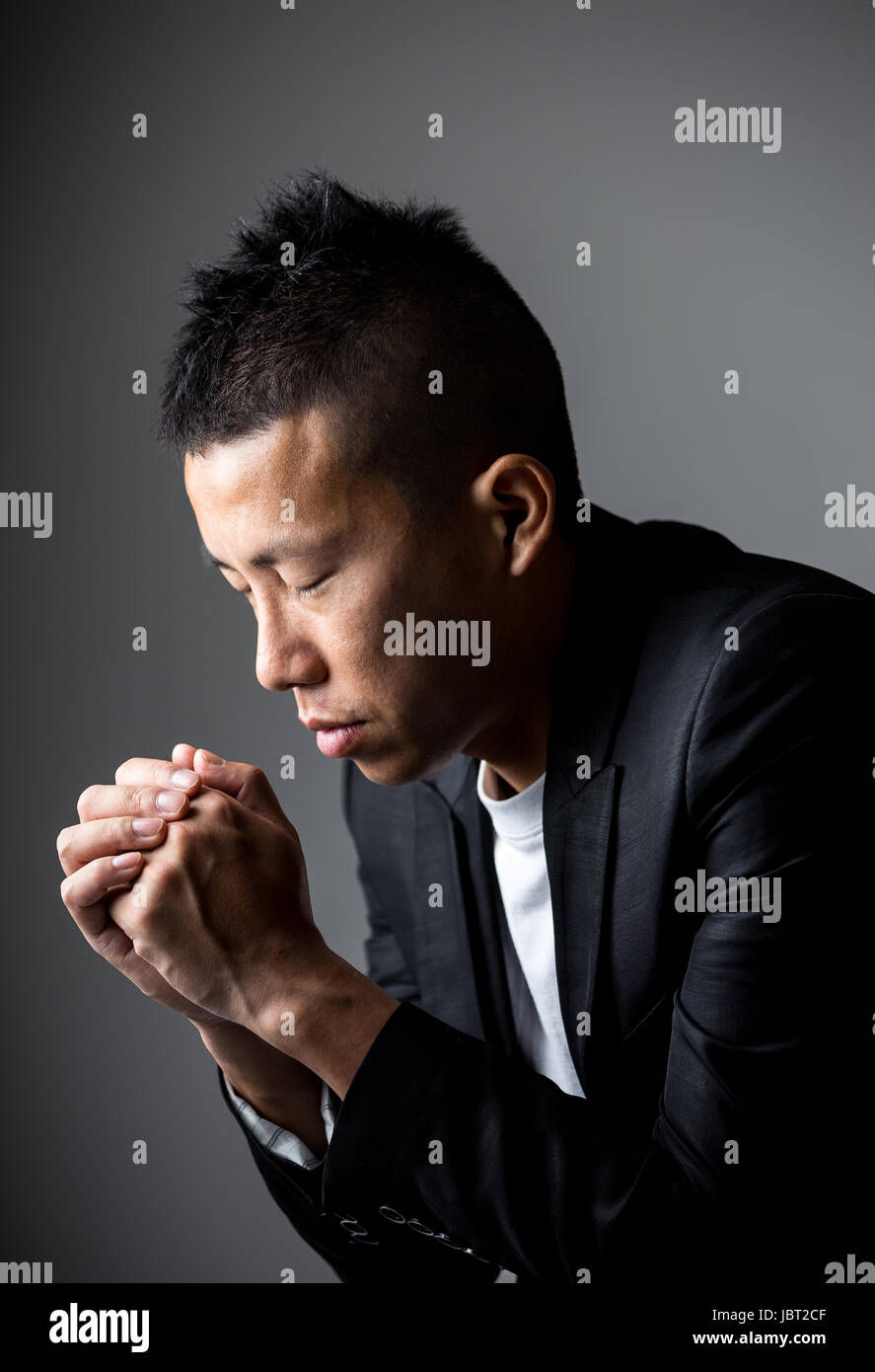 Young man praying Stock Photo - Alamy