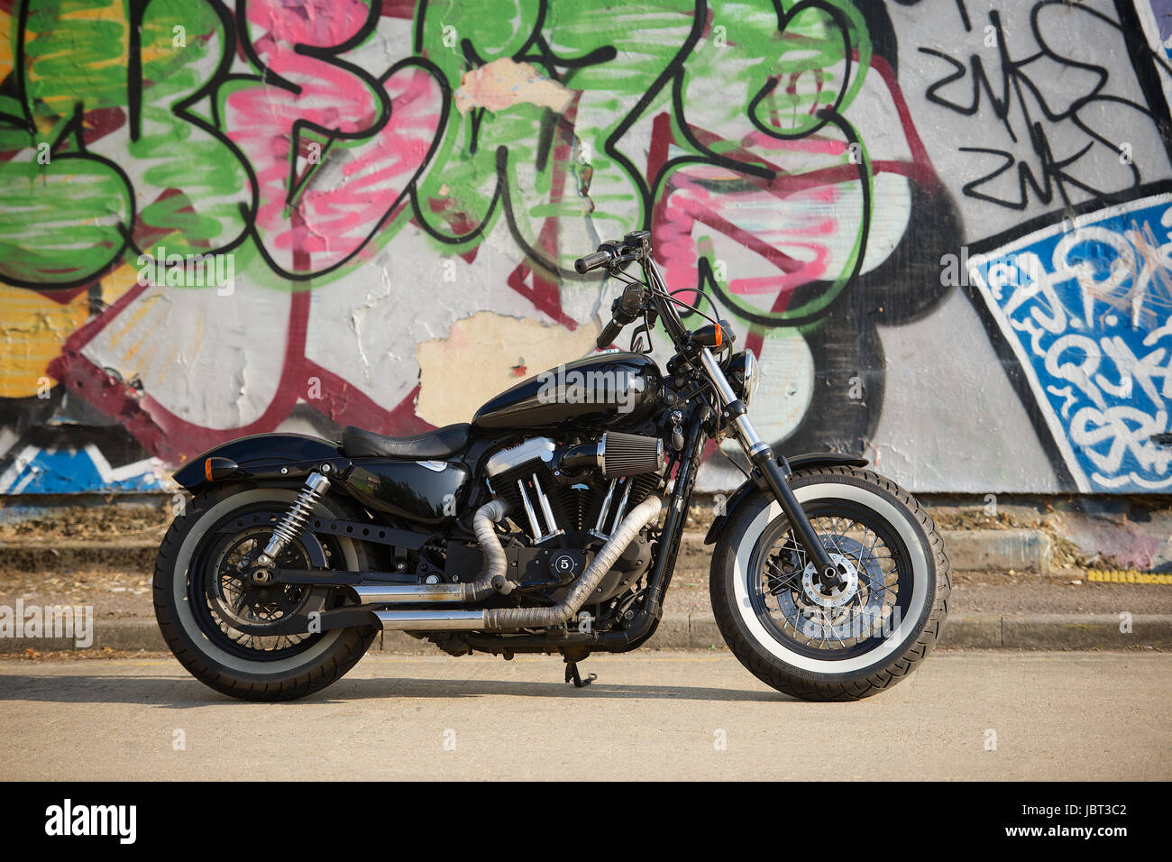 Harley Davidson 48 Sportster Motorcycle against a graffiti covered wall ...