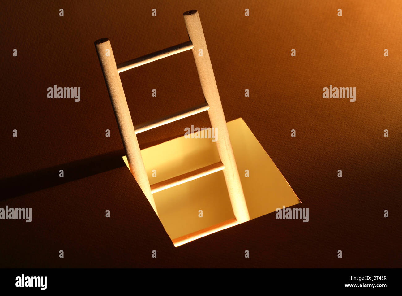 Abstract composition with wooden ladder inside luminous hole Stock ...