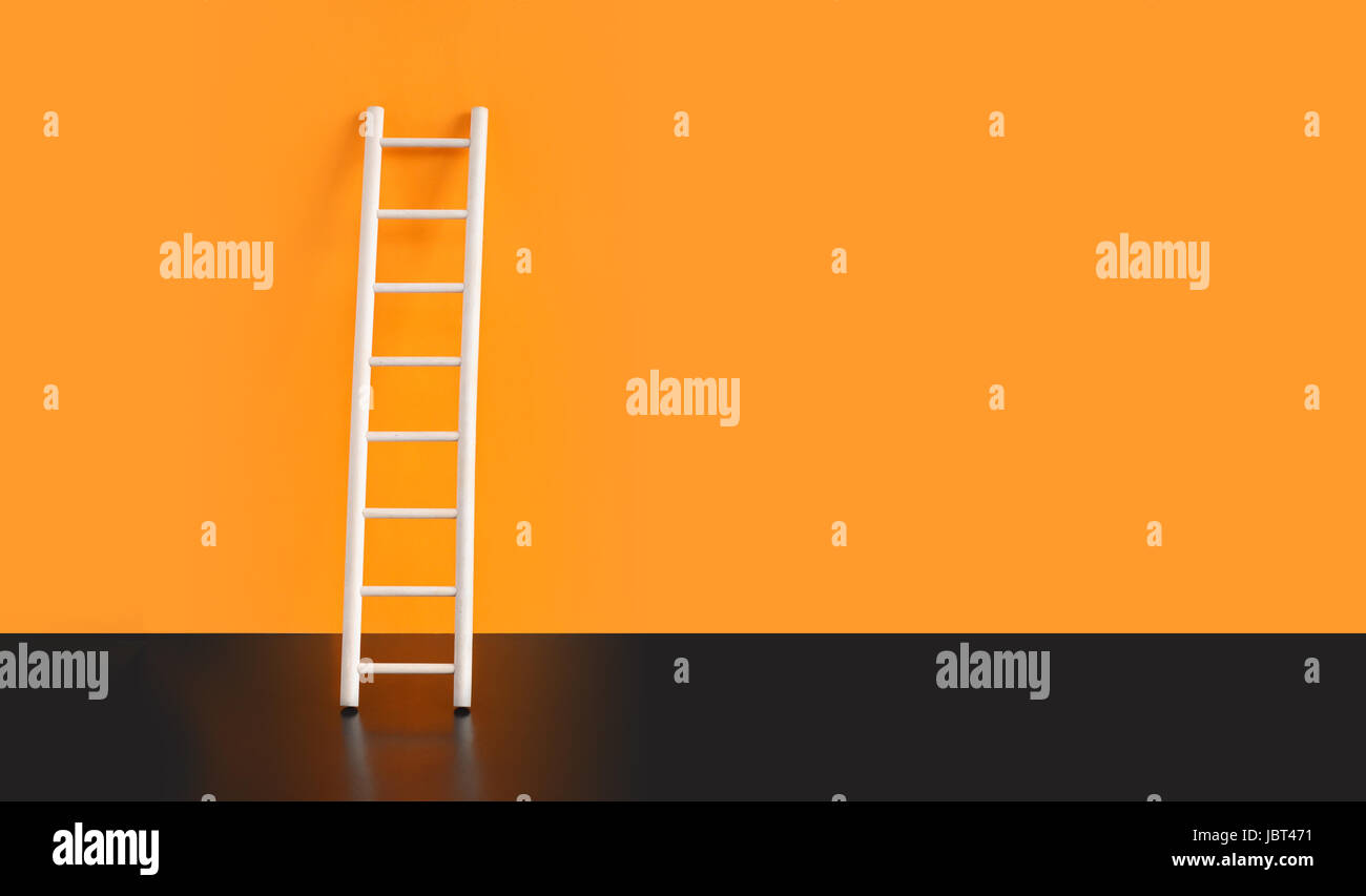 Wooden ladder on black floor against orange wall. Nice background with ...