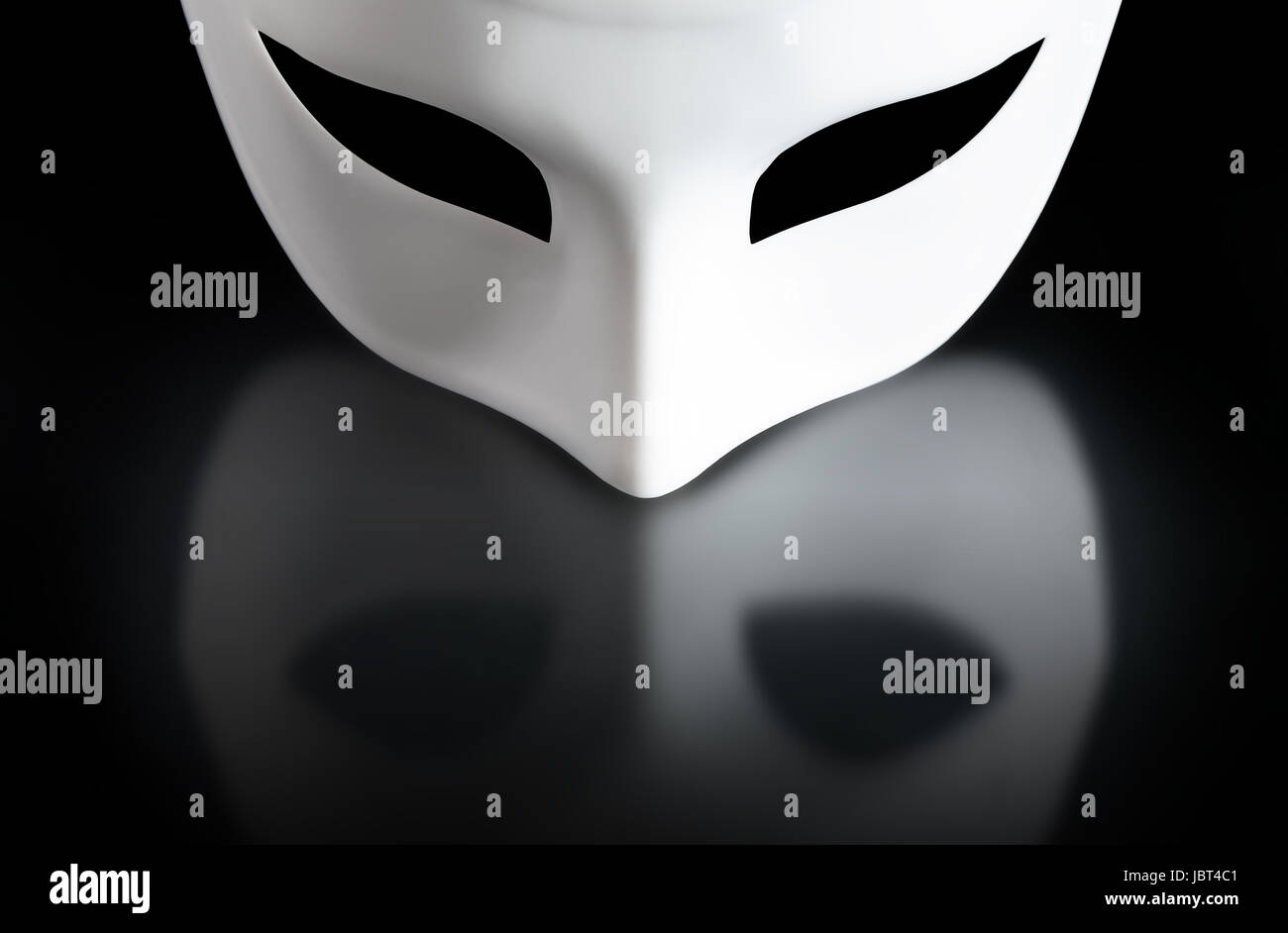 Art concept. Closeup of white mask on black background with reflection ...