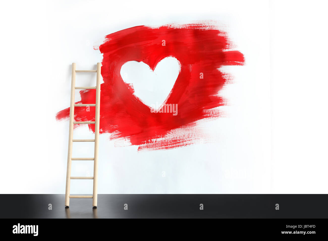 Love concept. Wooden ladder near white wall with big red painted heart ...