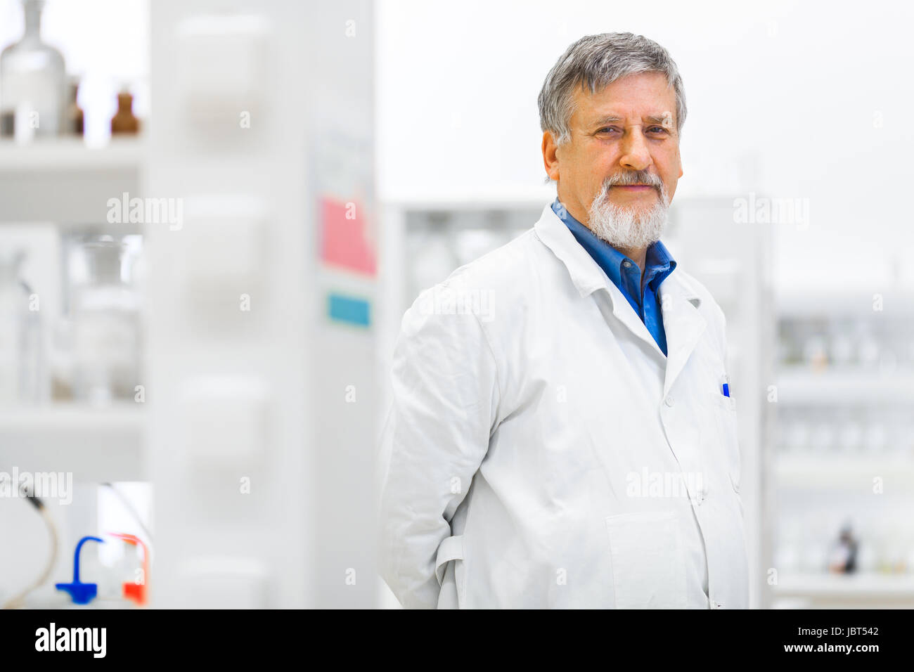 senior male researcher carrying out scientific research in a lab using ...
