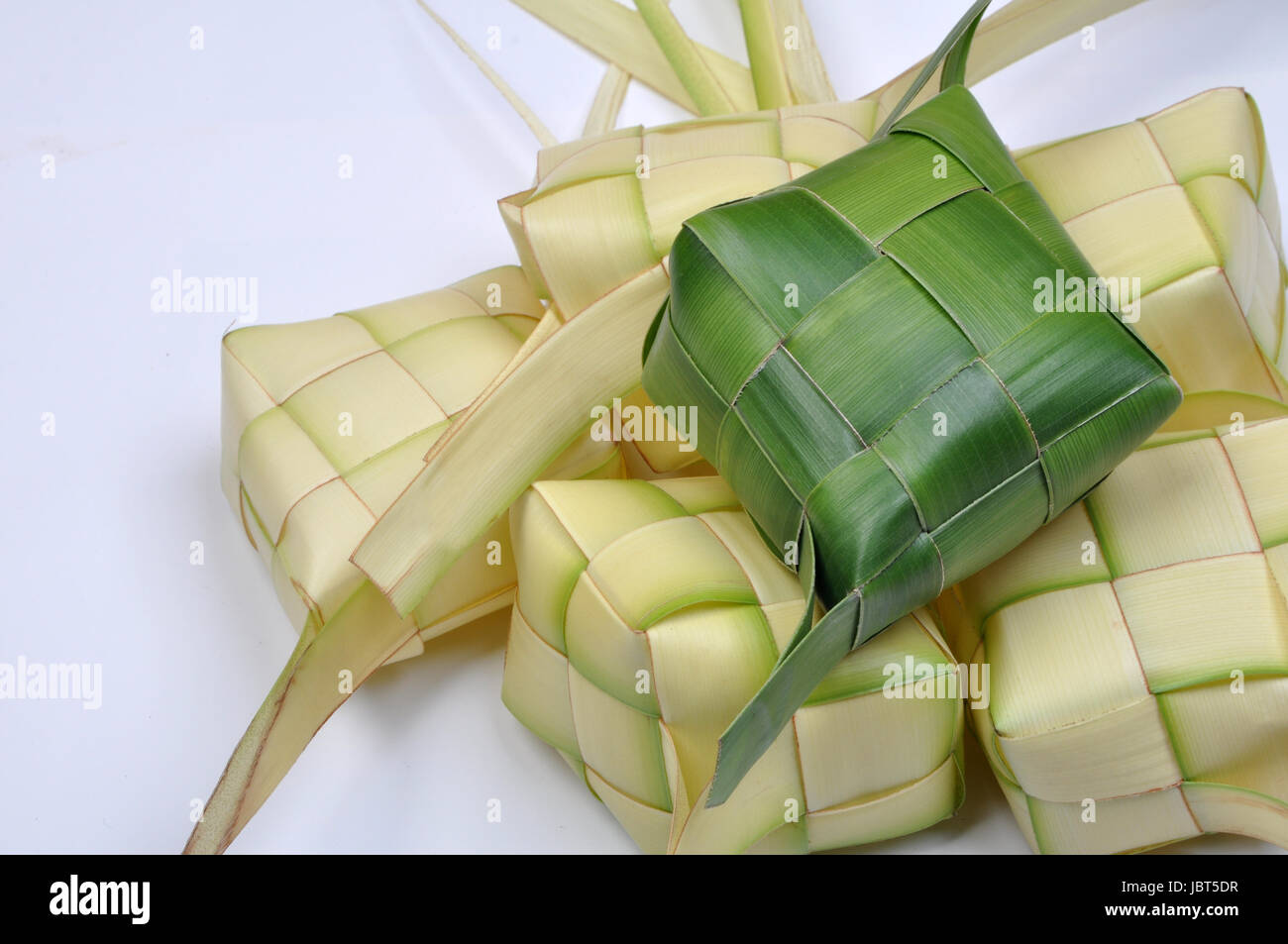 Ketupat, a type of dumpling made from rice packed inside a diamond ...