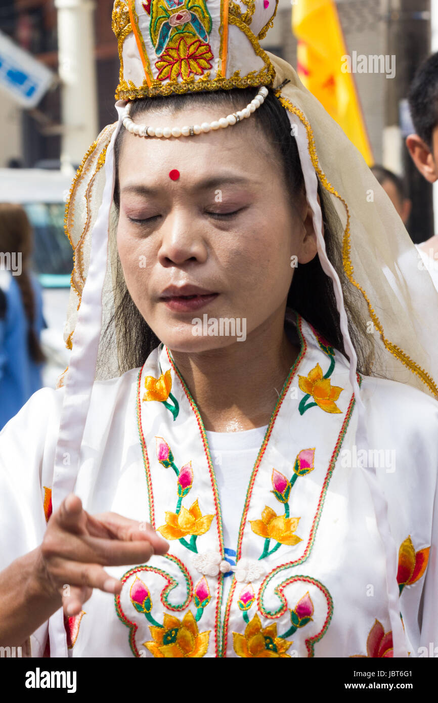 Woman spirit medium giving her blessing during a parade during the Nine ...