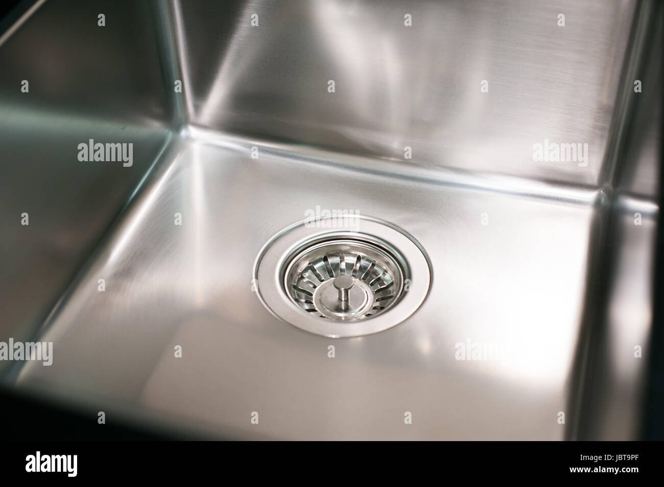 Angle view of kitchen sink with silver faucet Stock Photo - Alamy