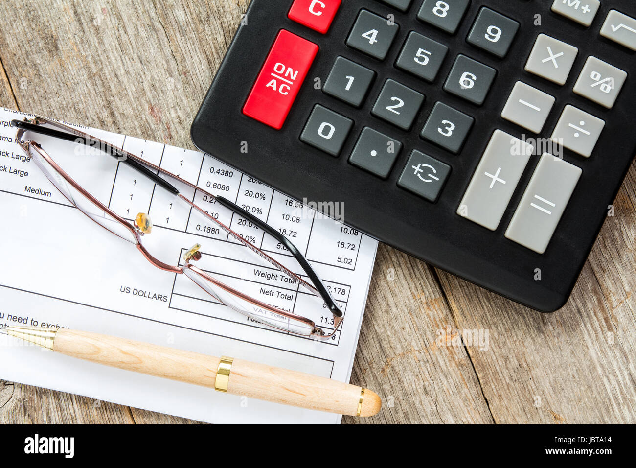 Invoice with balance due, calculator,pen and glasses Stock Photo - Alamy