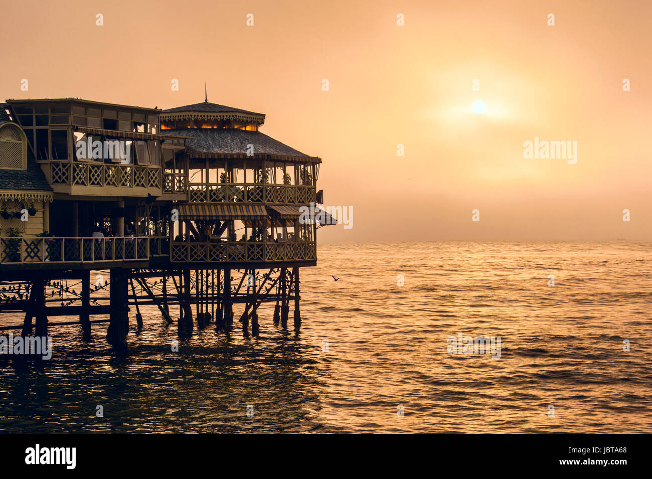 Evening Lima. Sunset on the Pacific Ocean, the sun breaks through the ...
