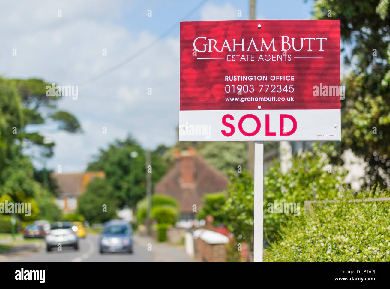 Sold sign outside a house. Graham Butt estate agents sold sign in the ...