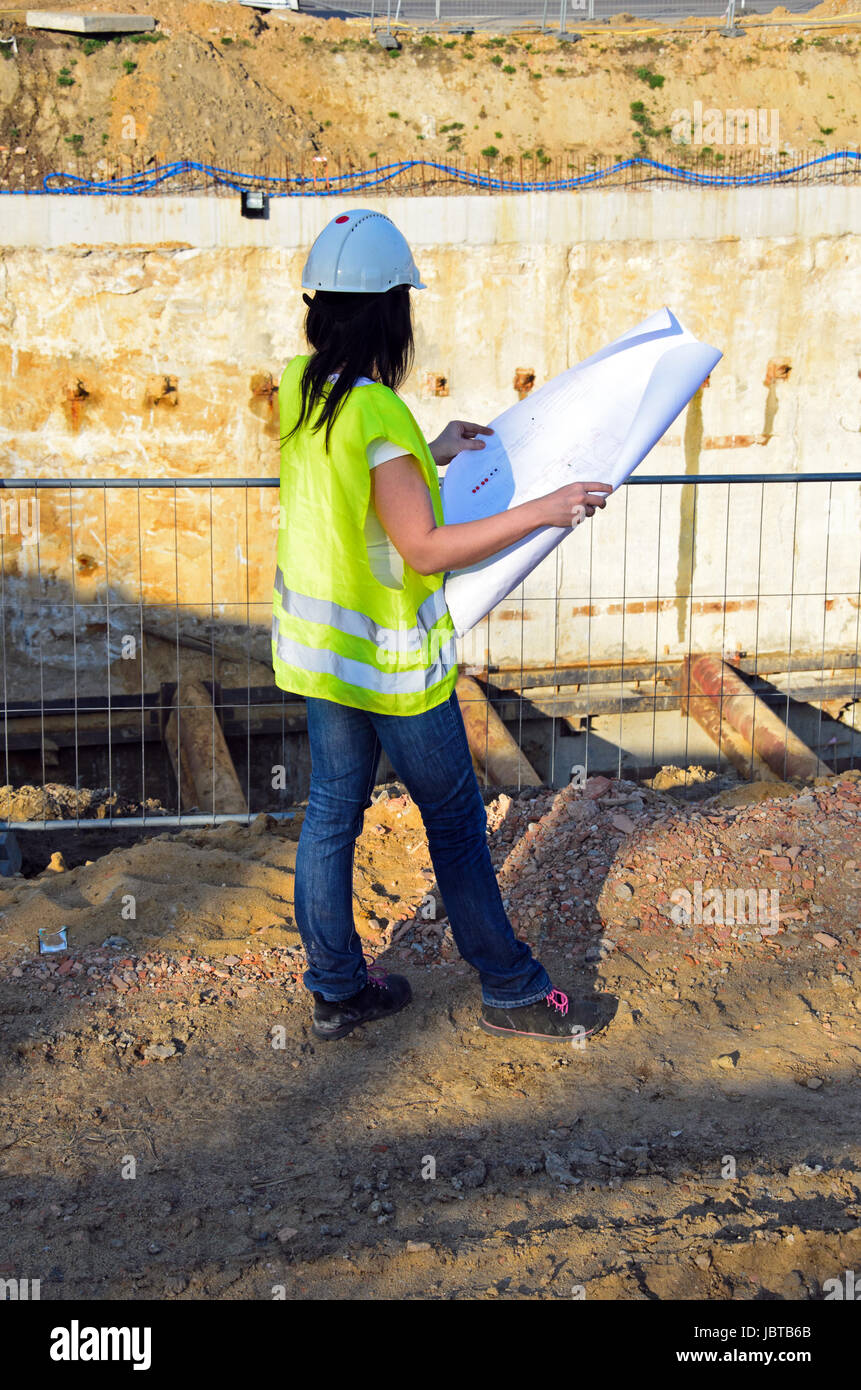a photo of a young woman architect on the building site of the ...