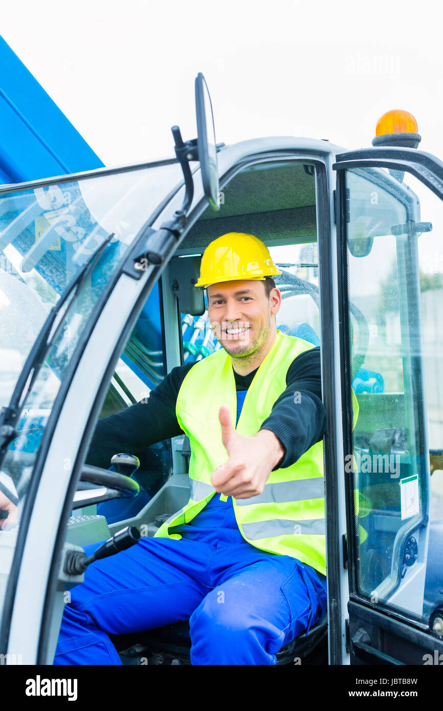 Construction worker driving excavation equipment hi-res stock ...