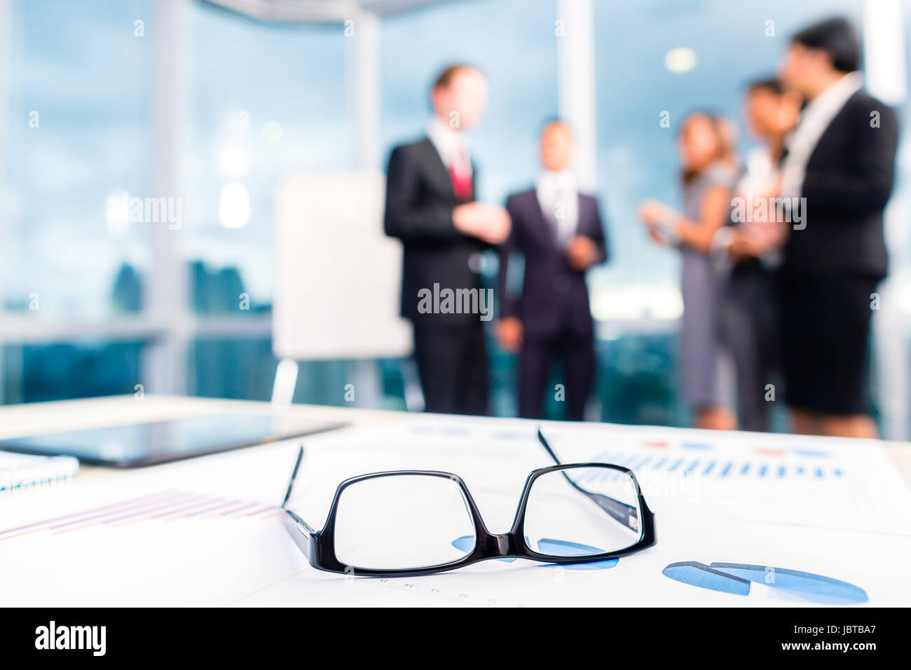 Glasses on office desk Stock Photo - Alamy