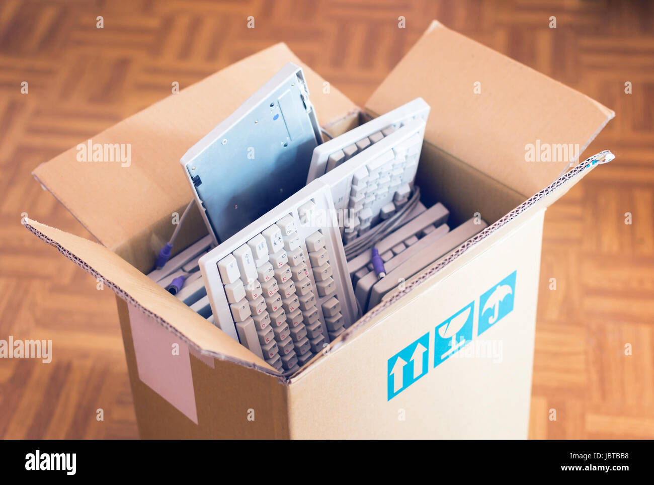 Office move - cardboard box with lots of computer keyboards Stock Photo ...