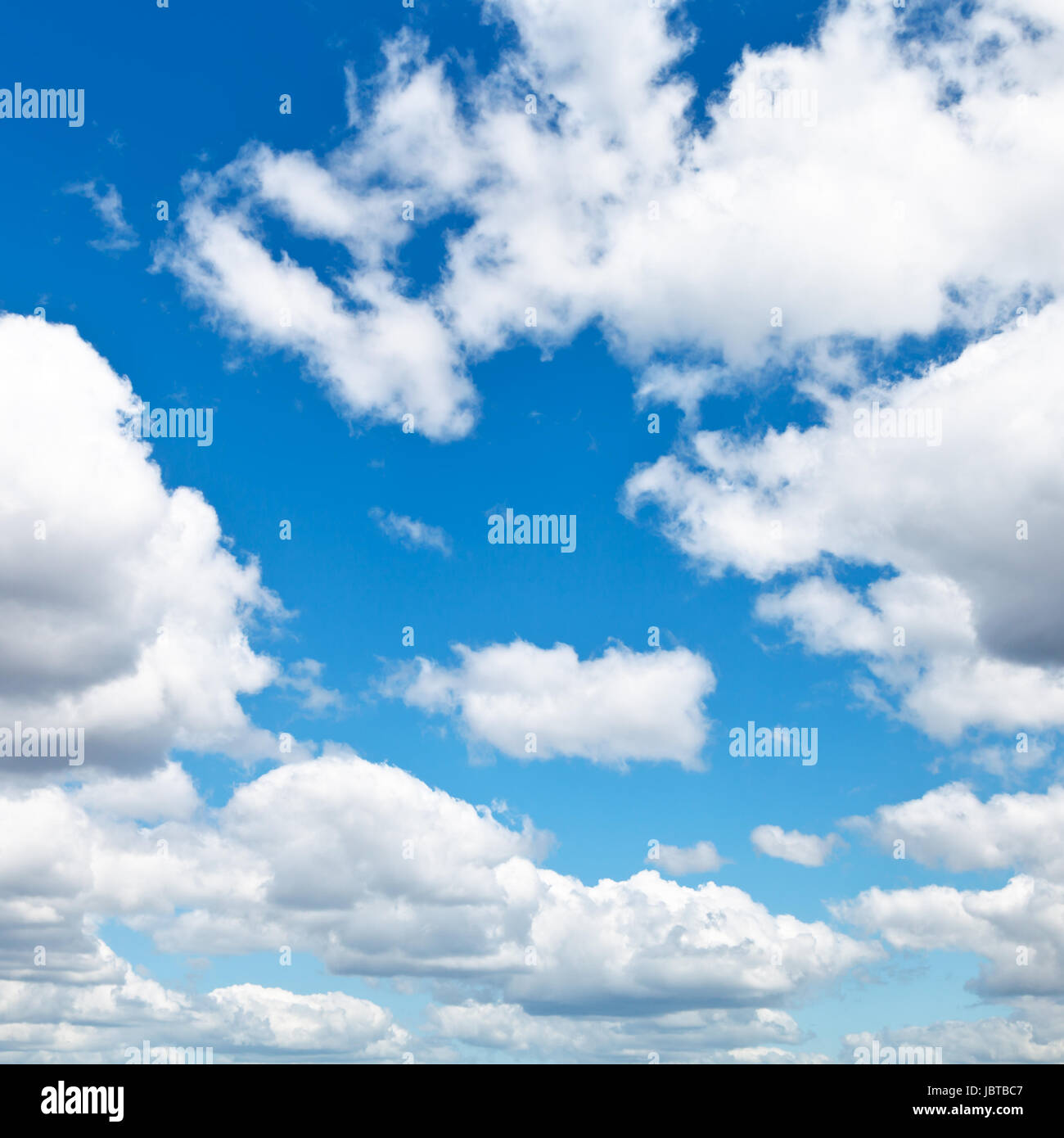 woolpack clouds in blue sky in summer day Stock Photo - Alamy
