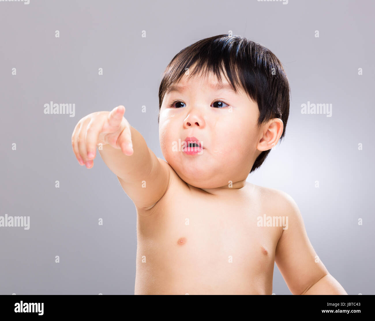 Baby boy finger point to front Stock Photo - Alamy