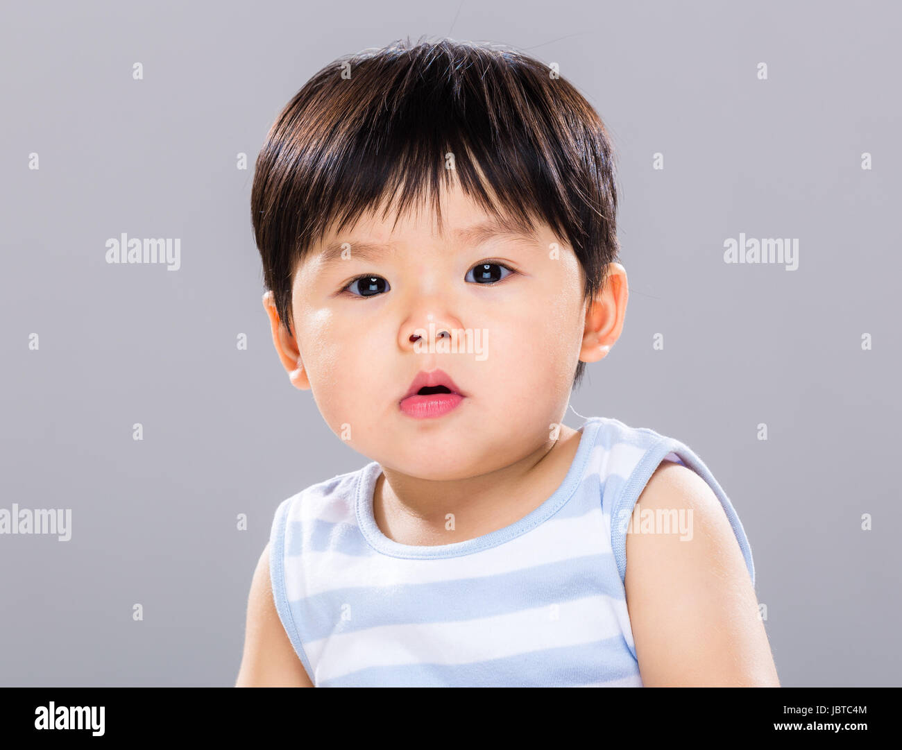 Serious baby boy Stock Photo - Alamy